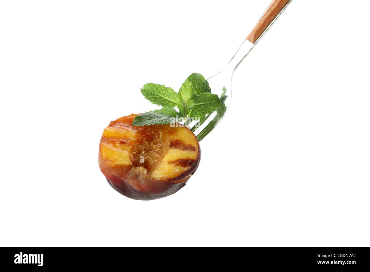 Fork with grilled peach isolated on white background Stock Photo - Alamy