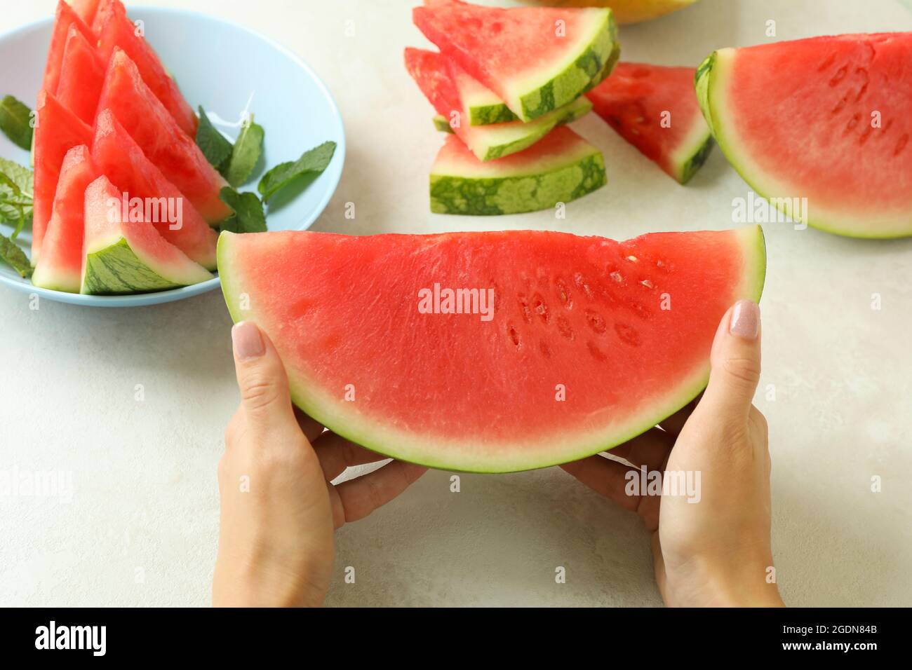 Female hands hold watermelon slice, close up Stock Photo - Alamy