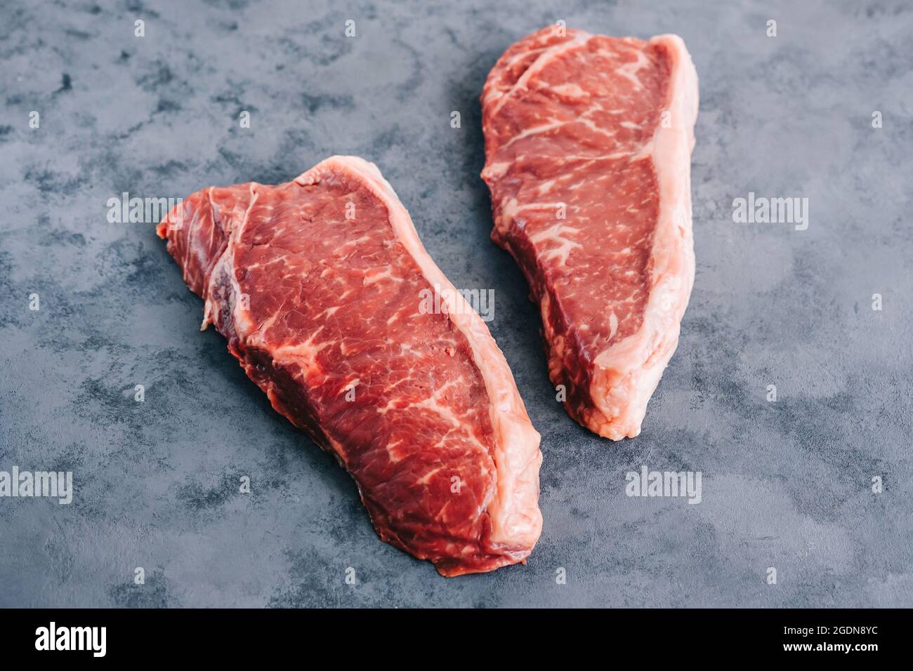 Raw New York striploin beef steak isolated on gray background Stock ...