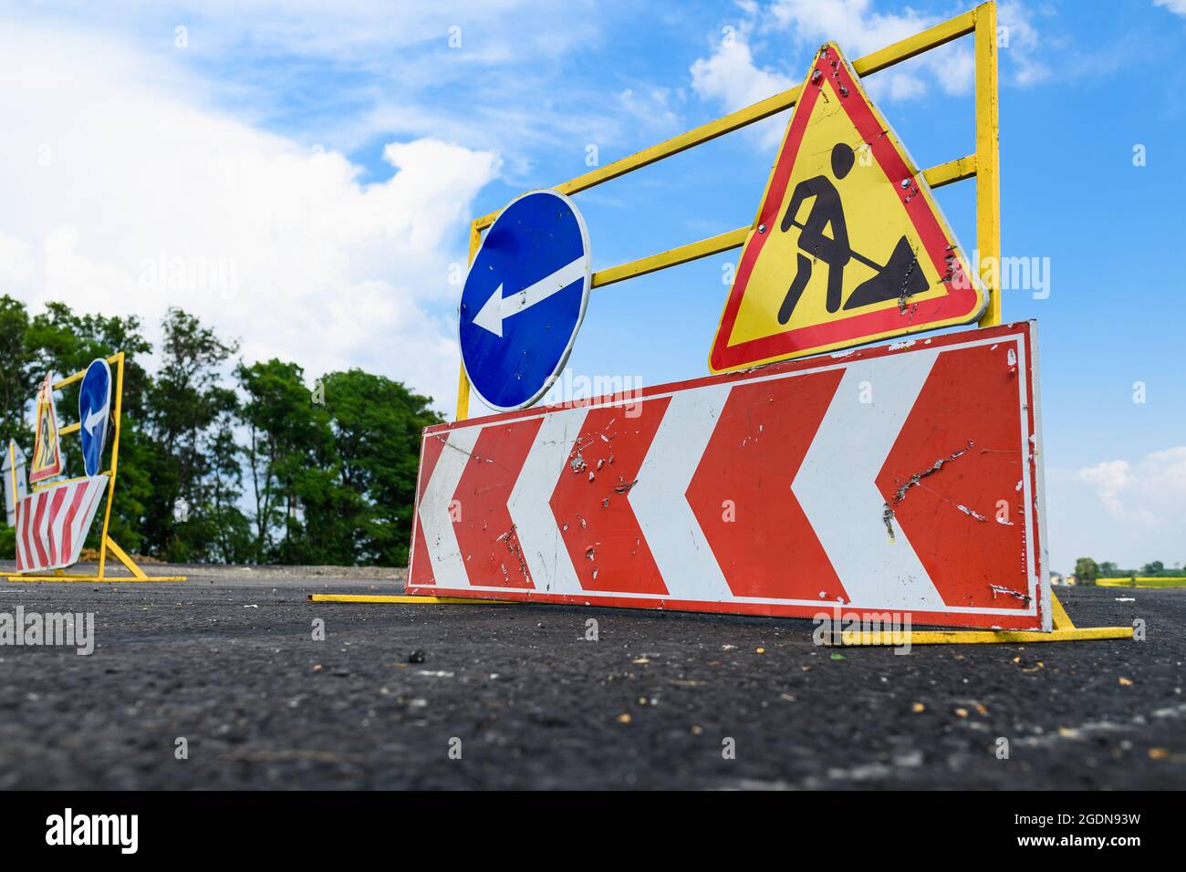 Road works sign on the road. Repair work of road signs and a bypass ...