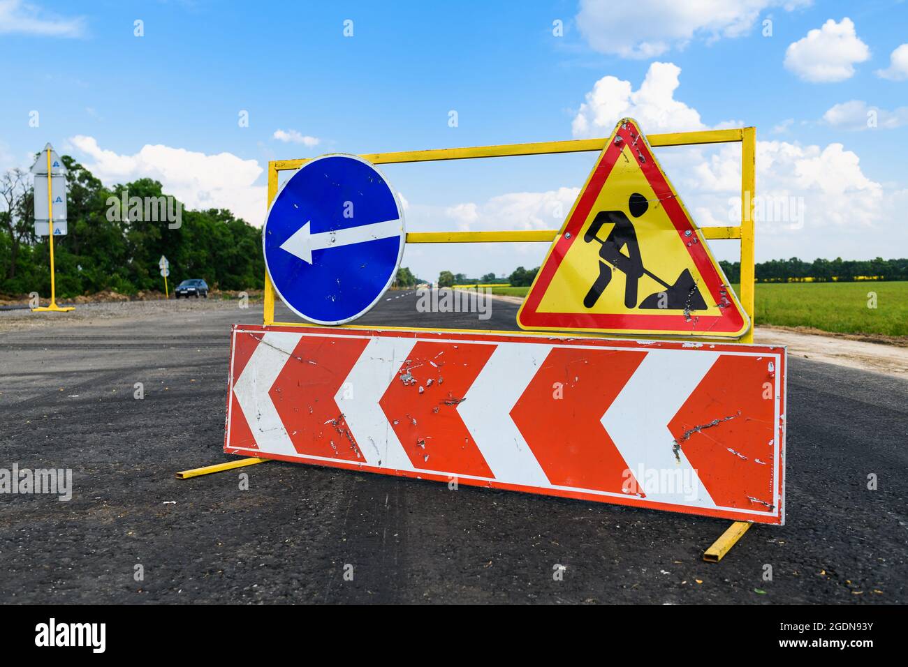 Road works sign on the road. Repair work of road signs and a bypass ...