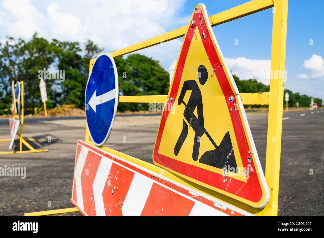 Road works sign on the road. Repair work of road signs and a bypass ...