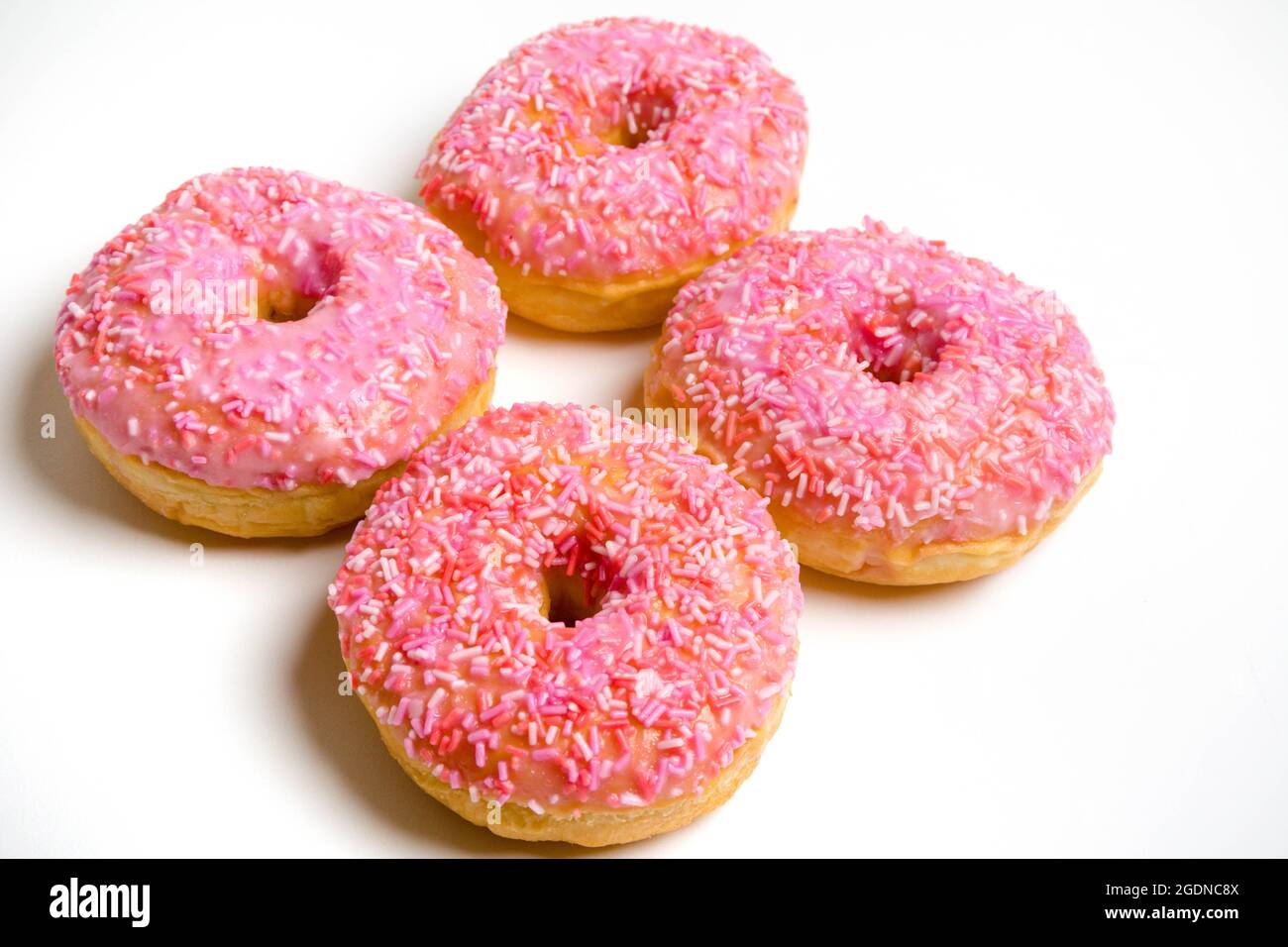 Four Iced Ring Donuts On A White Background Stock Photo - Alamy