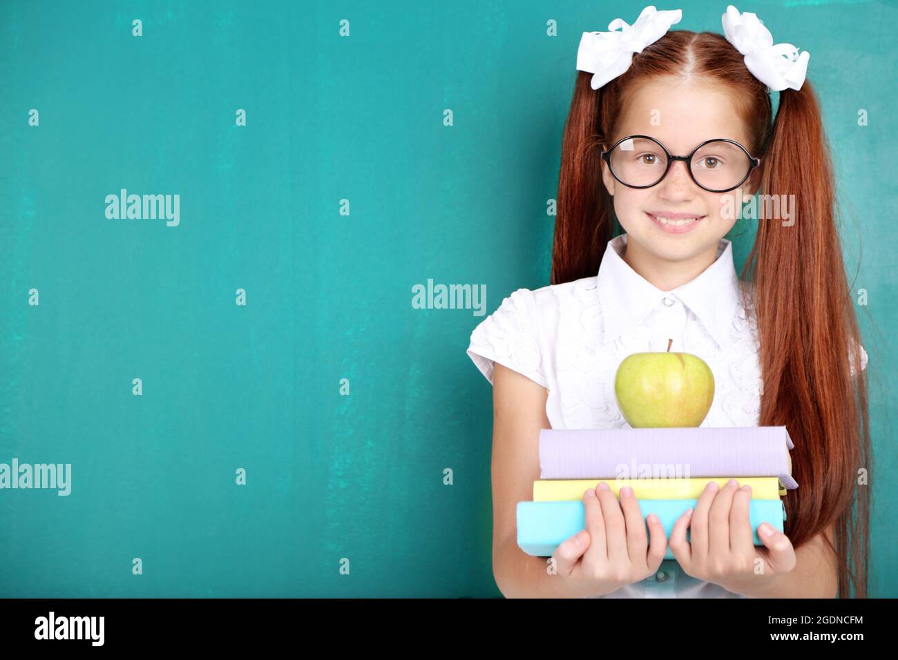 Cute girl standing near blackboard in classroom Stock Photo - Alamy