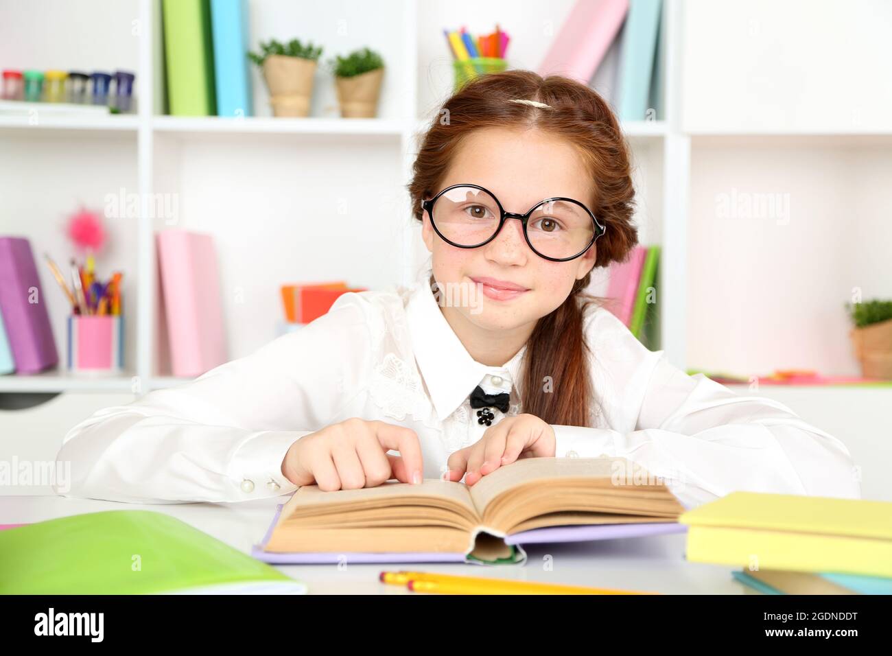 Cute girl at workplace in classroom Stock Photo - Alamy