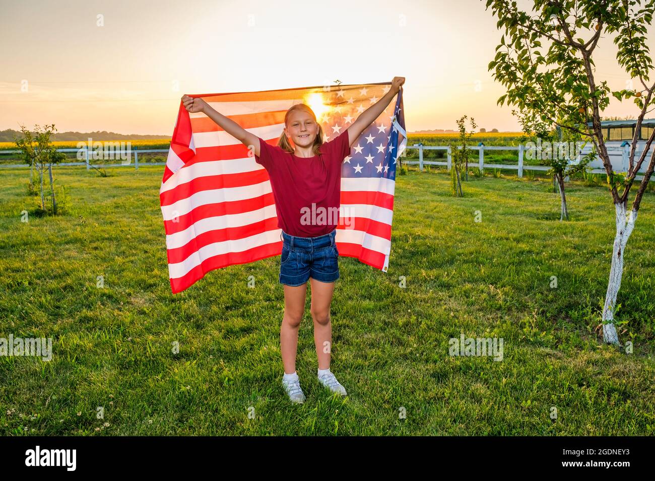 Girl celebrating Independence Day at sunset Stock Photo - Alamy
