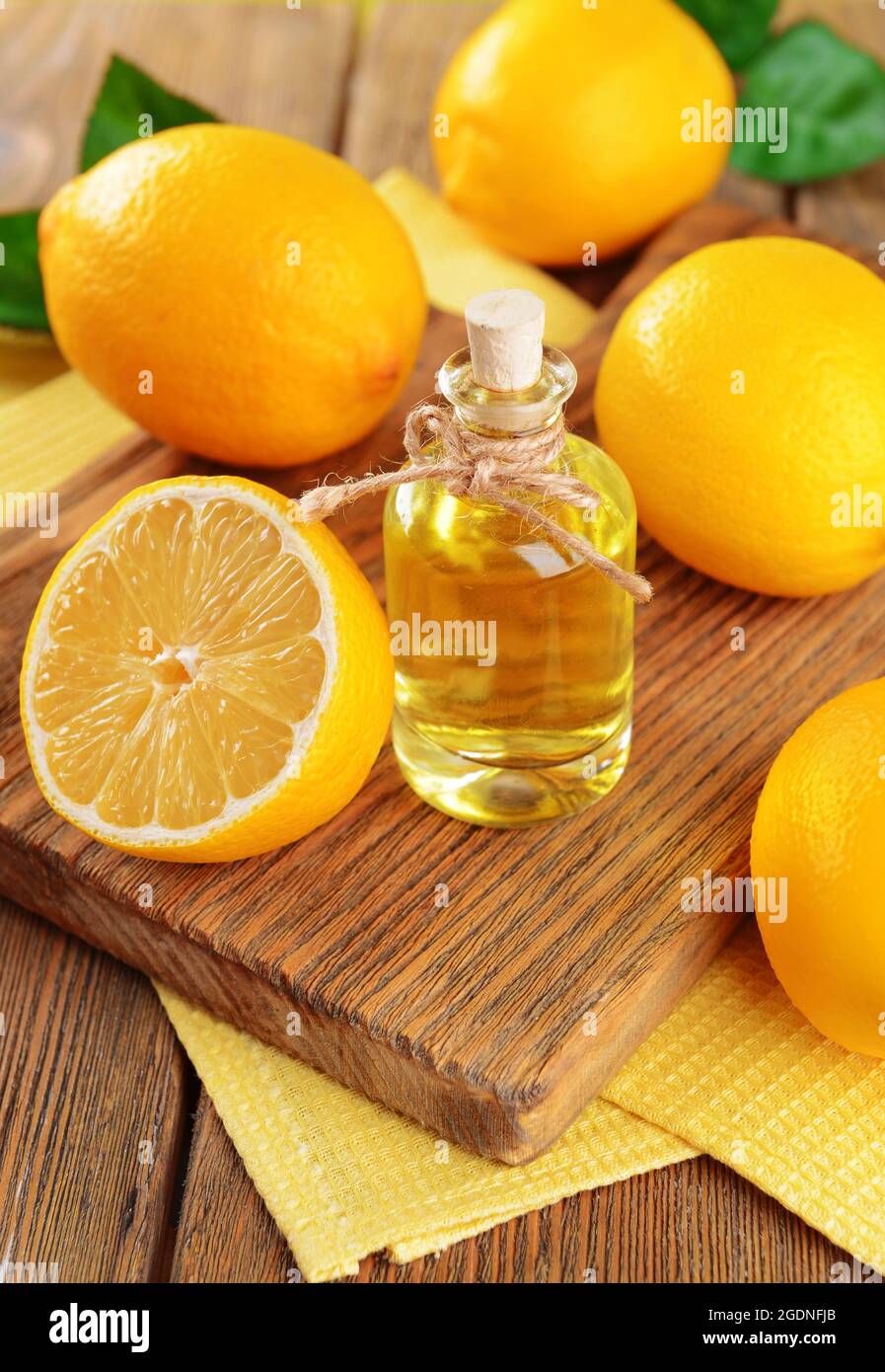 Lemon oil on table on light background Stock Photo - Alamy