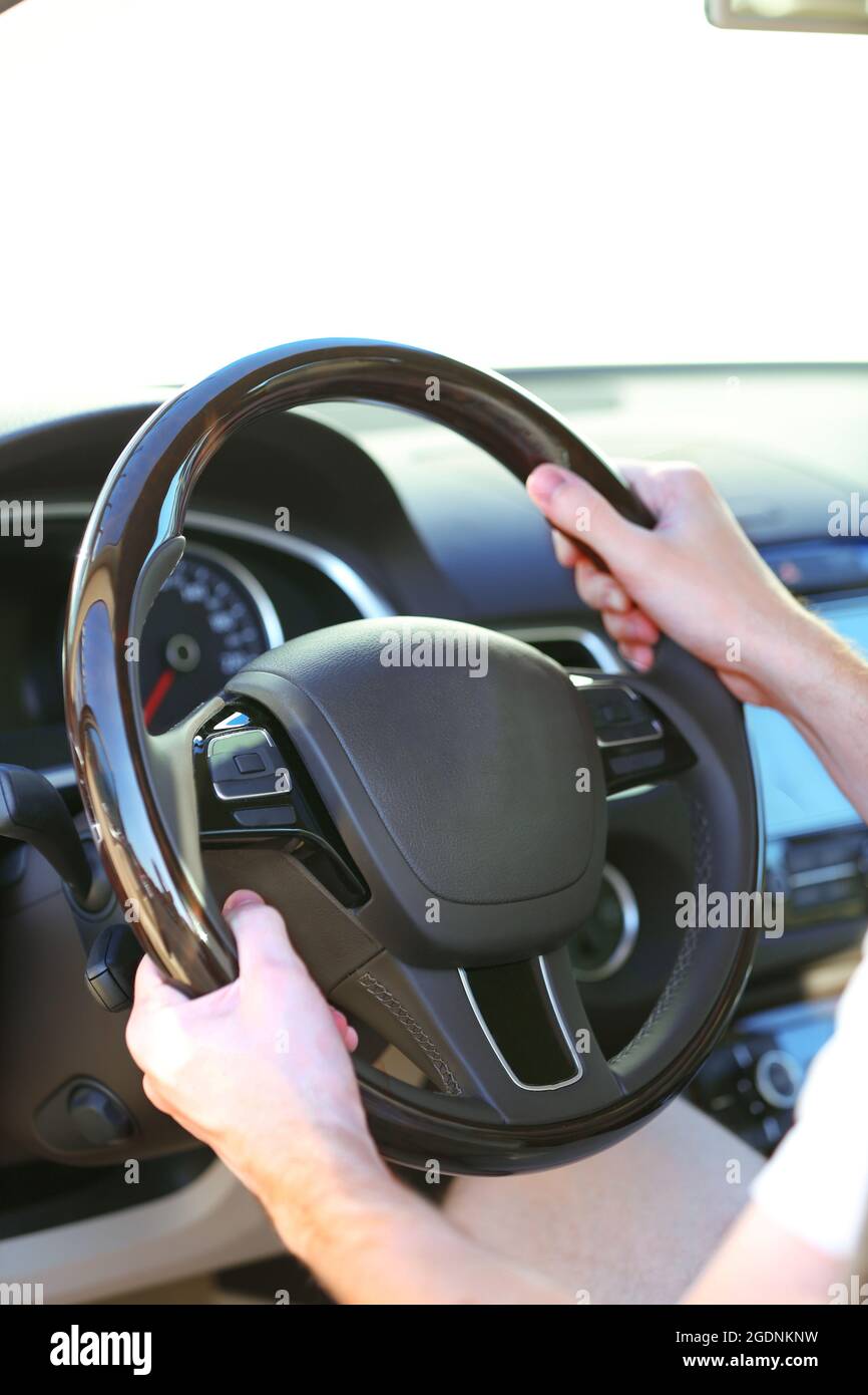 Man's hands on a steering wheel Stock Photo - Alamy