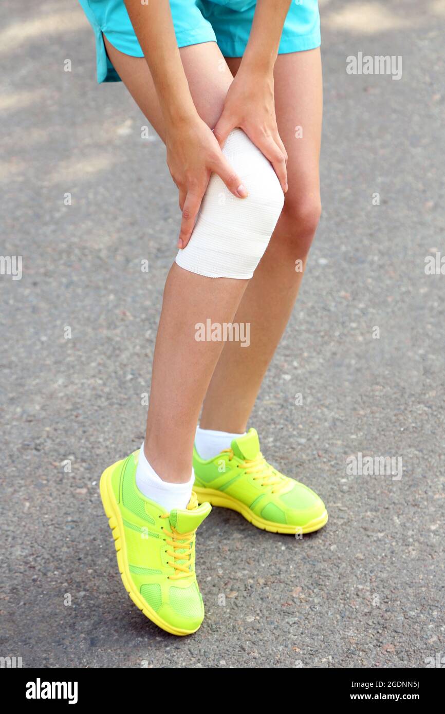 Sports injuries of girl outdoors Stock Photo - Alamy