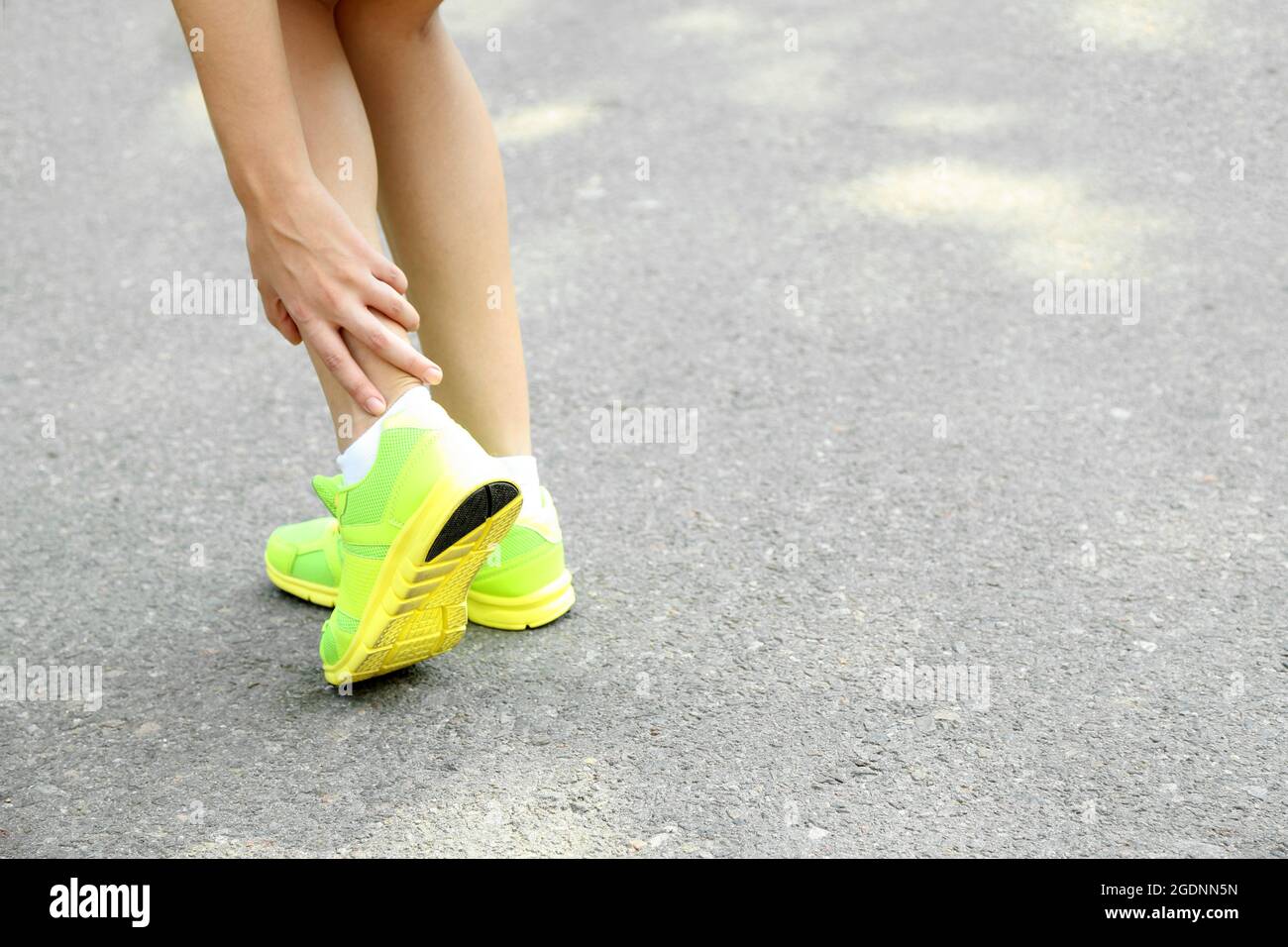 Sports injuries of girl outdoors Stock Photo - Alamy