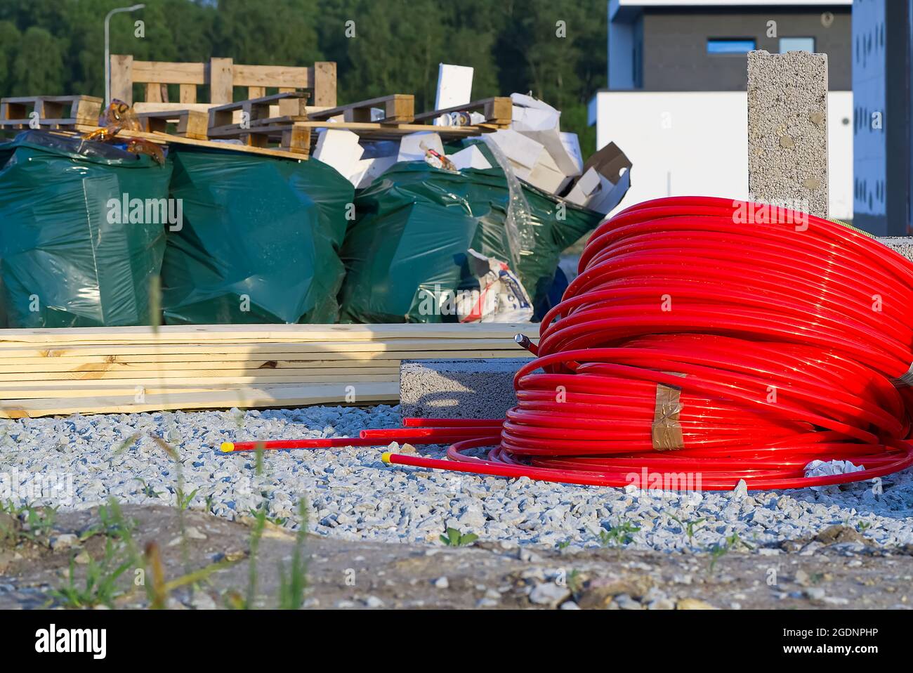 Construction waste in front of an unfinished building. rubbish in front ...