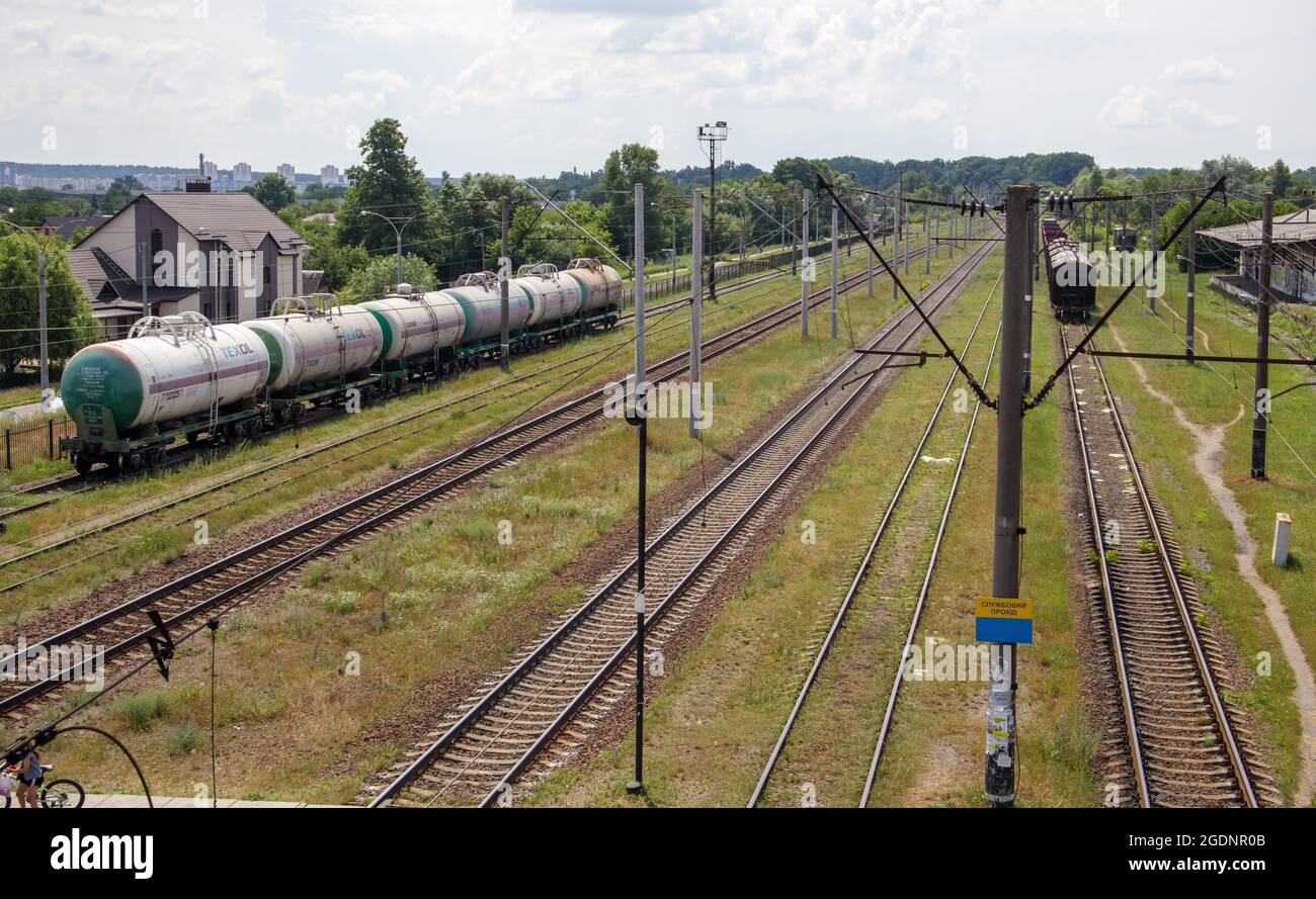 Railway stations with carriages and railroad tracks and trains ...