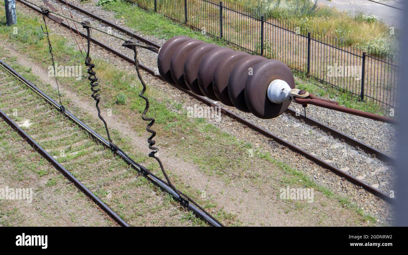 A railroad overhead power line component along a track with a rail electrification system that ...