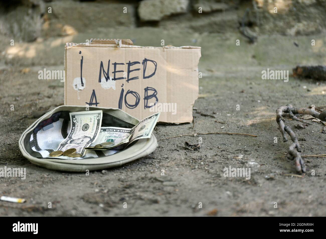Hat homeless outdoors Stock Photo - Alamy