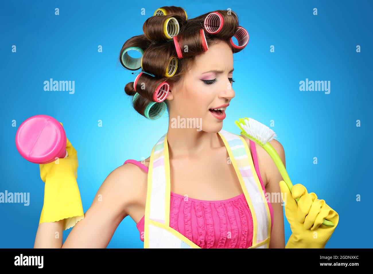 Beautiful girl in hair curlers on blue background Stock Photo - Alamy