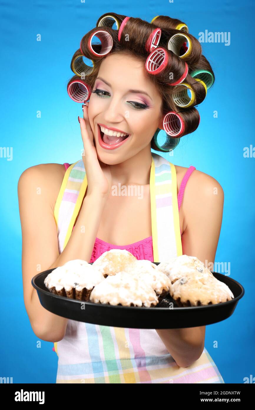 Beautiful girl in hair curlers on blue background Stock Photo - Alamy