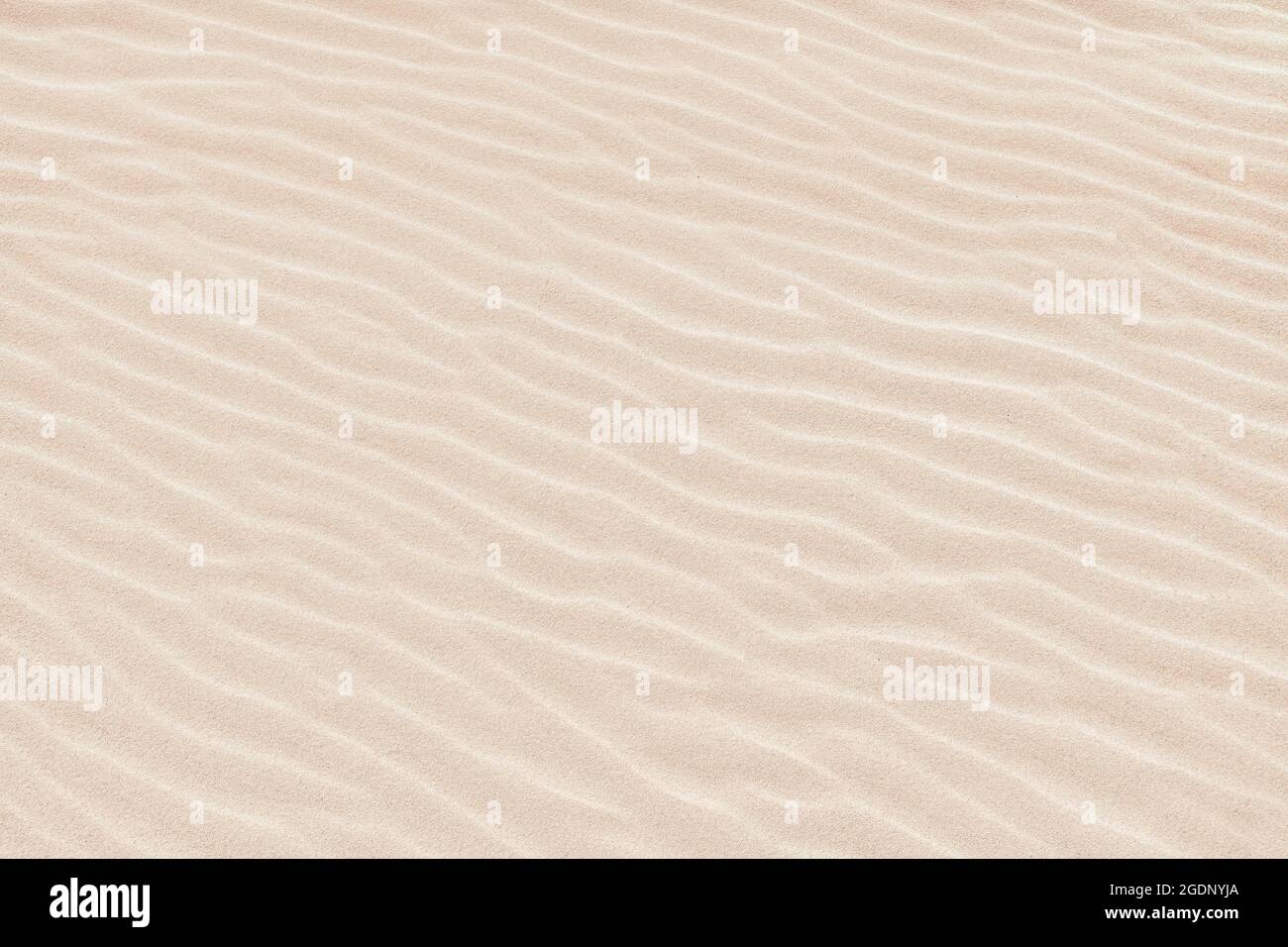 Abstract background. Diagonal sand stripes texture made by sea waves on ...