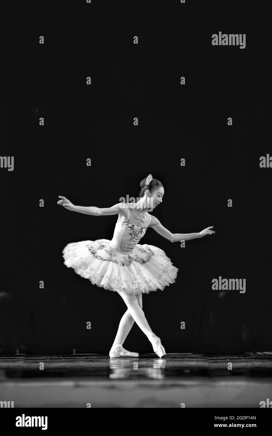 BUSAN, KOREA, SOUTH - Jun 26, 2019: A ballet dancer on a dark stage ...