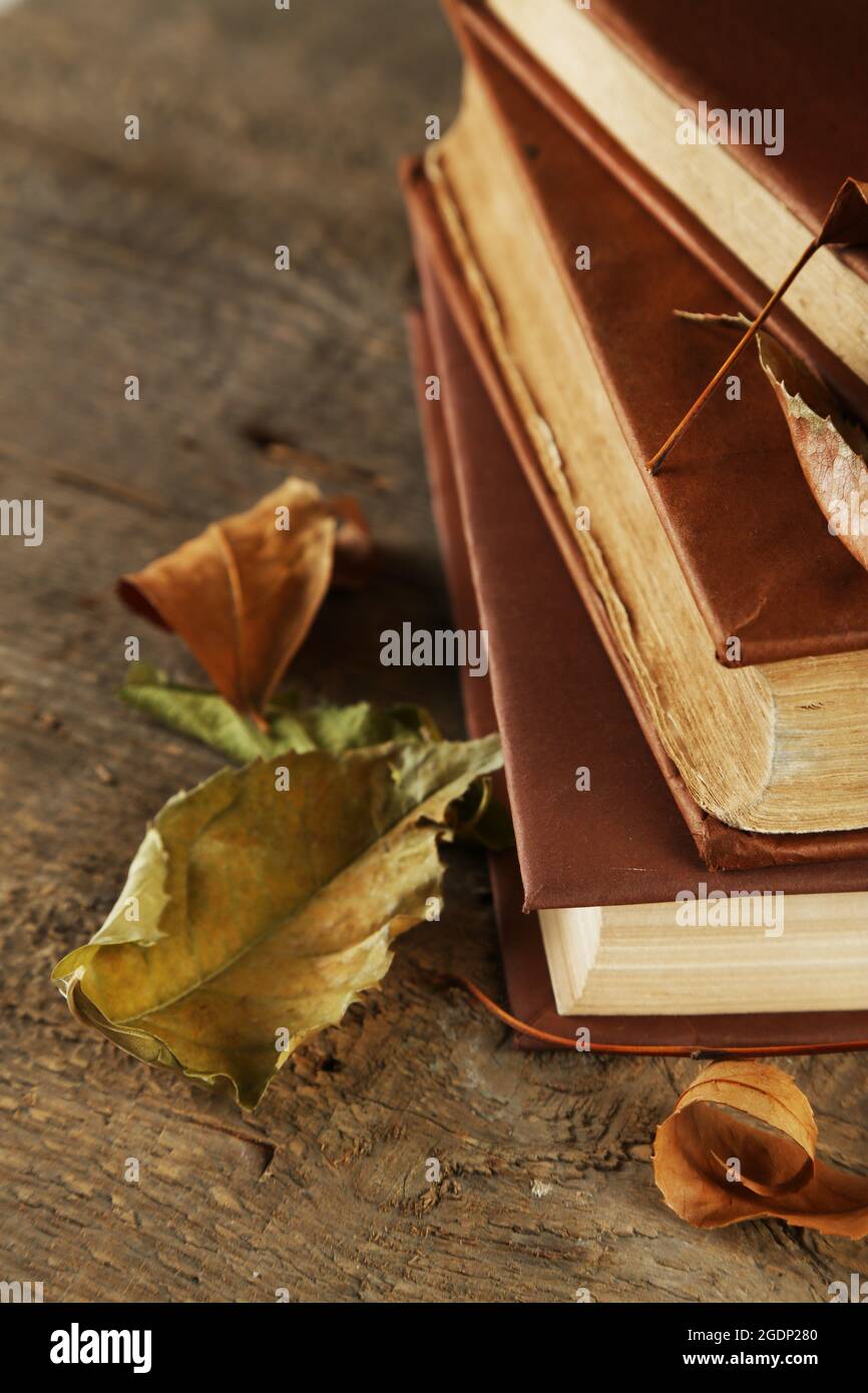 Books and dry leaves on wooden background Stock Photo - Alamy