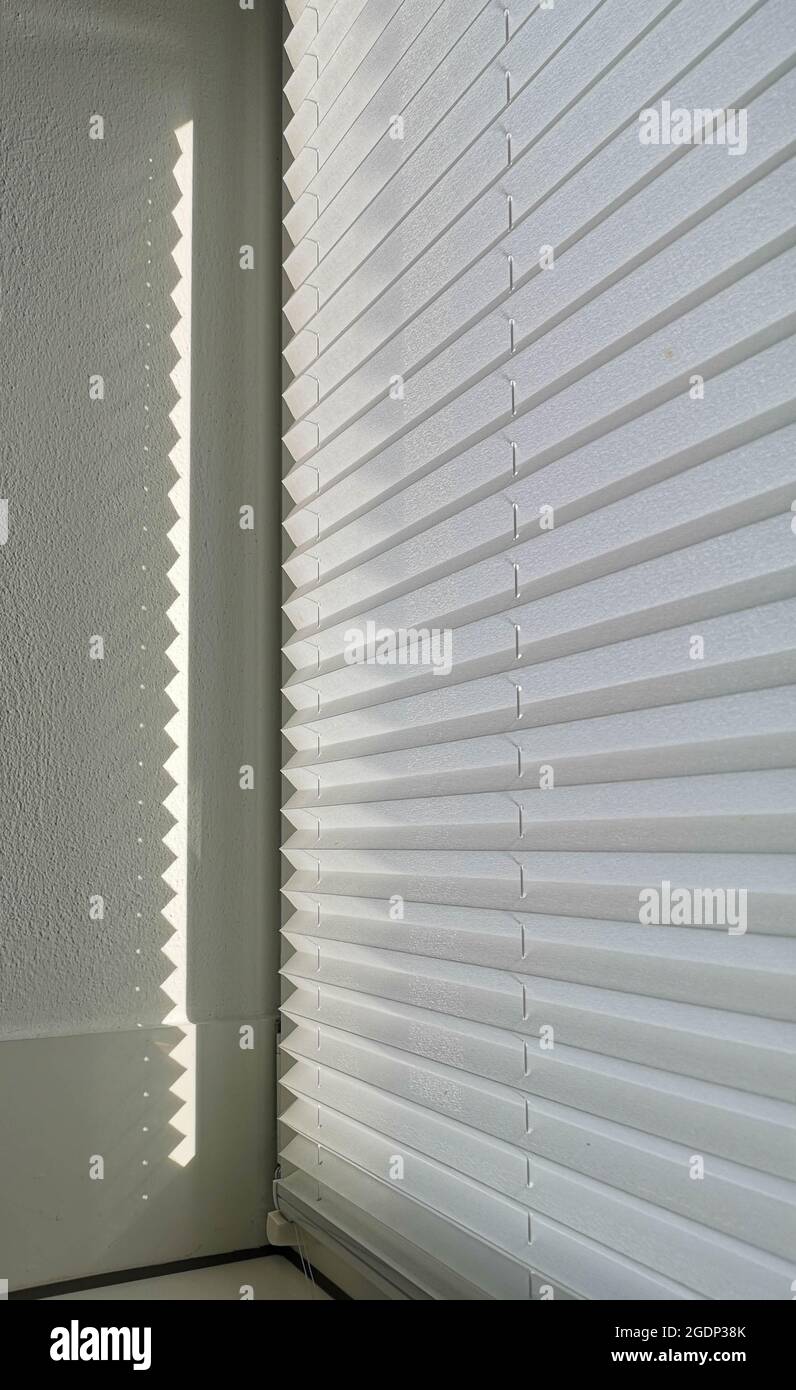 Sun light coming through sun blinders and hitting to the wall Stock ...