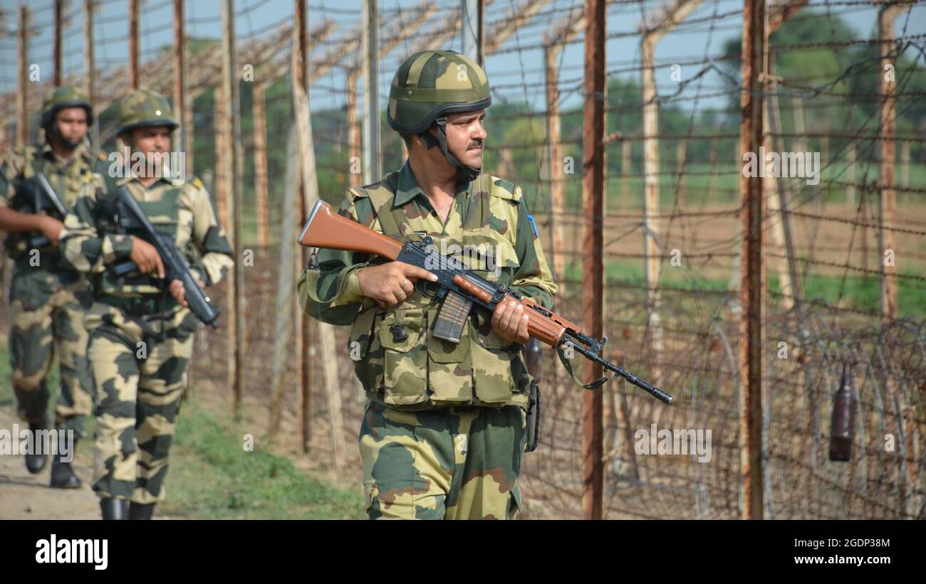 Border Security Force (BSF) personnel patrolling along the barbed wire ...