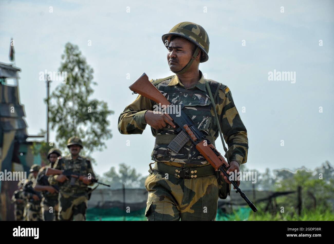 Border Security Force (BSF) personnel patrolling along the barbed wire ...