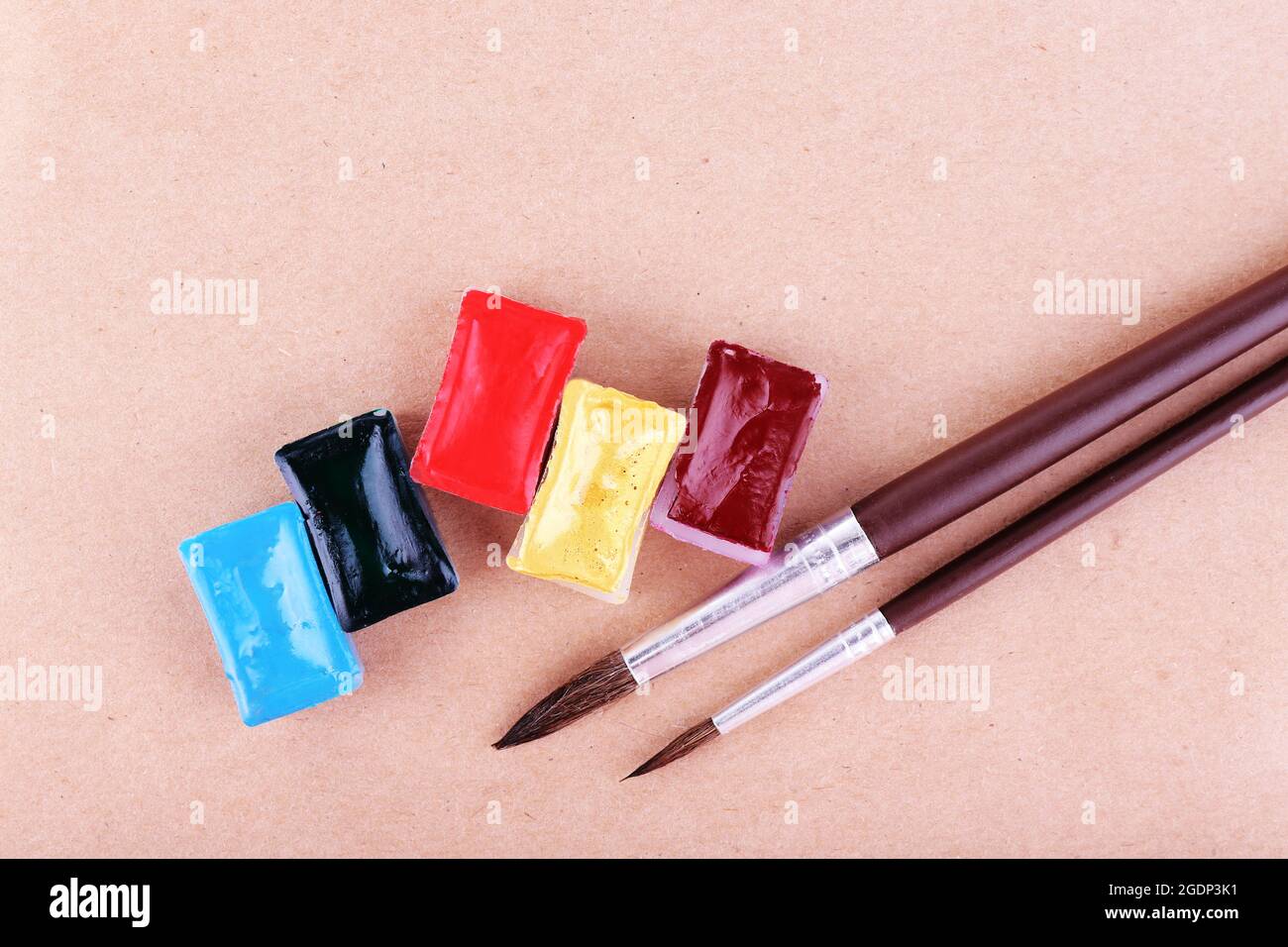 Watercolor paint cubes and brushes on beige background Stock Photo - Alamy