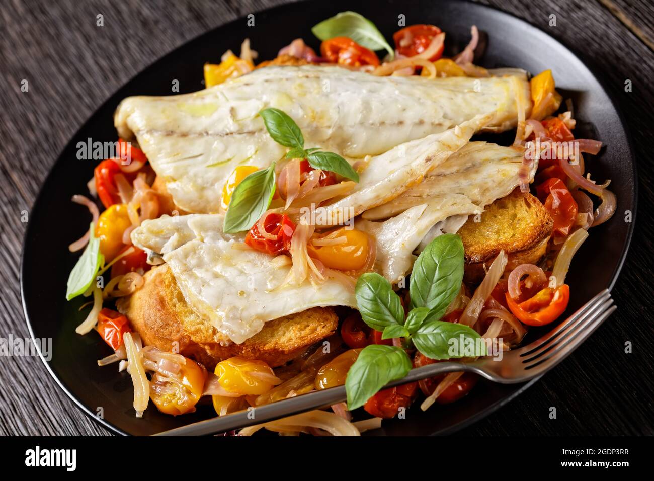 close-up of Acqua Pazza, italian poached fish in a tomato and white ...