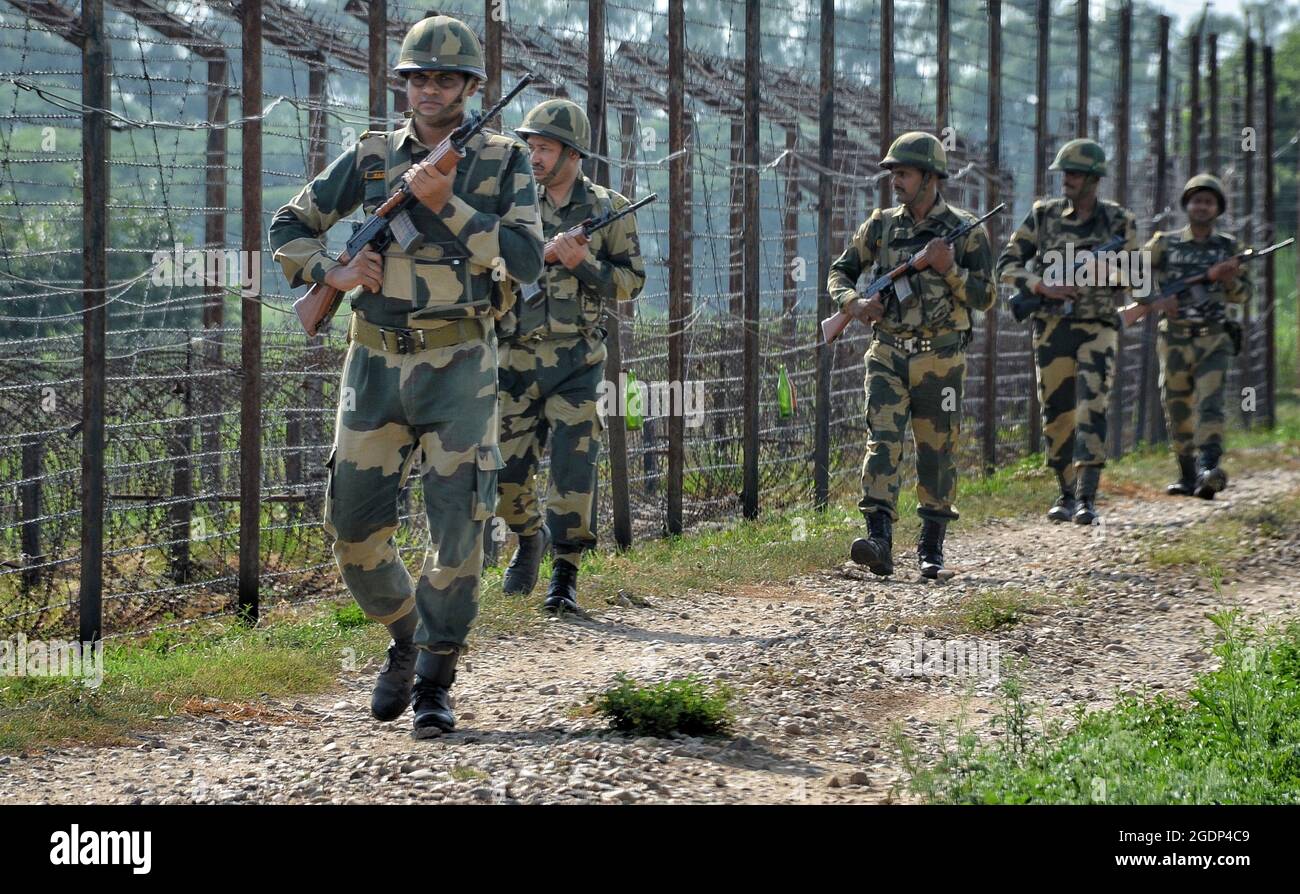 Border Security Force (BSF) personnel patrolling along the barbed wire ...