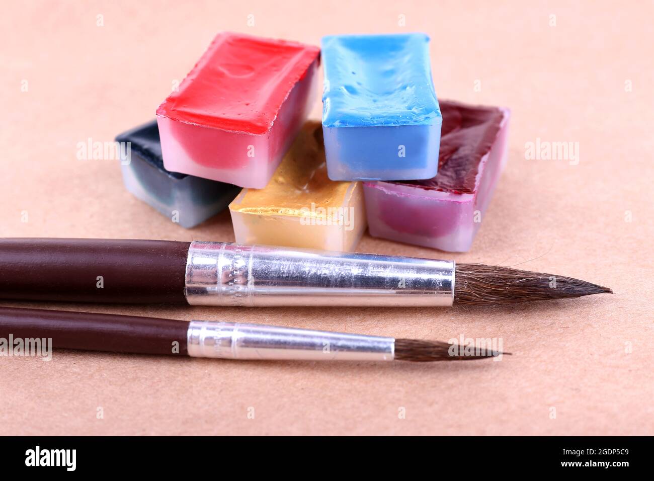 Watercolor paint cubes and brushes on beige background Stock Photo - Alamy