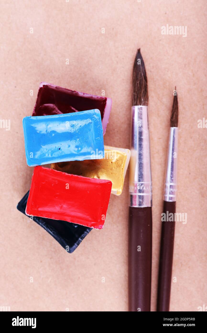 Watercolor paint cubes and brushes on beige background Stock Photo - Alamy