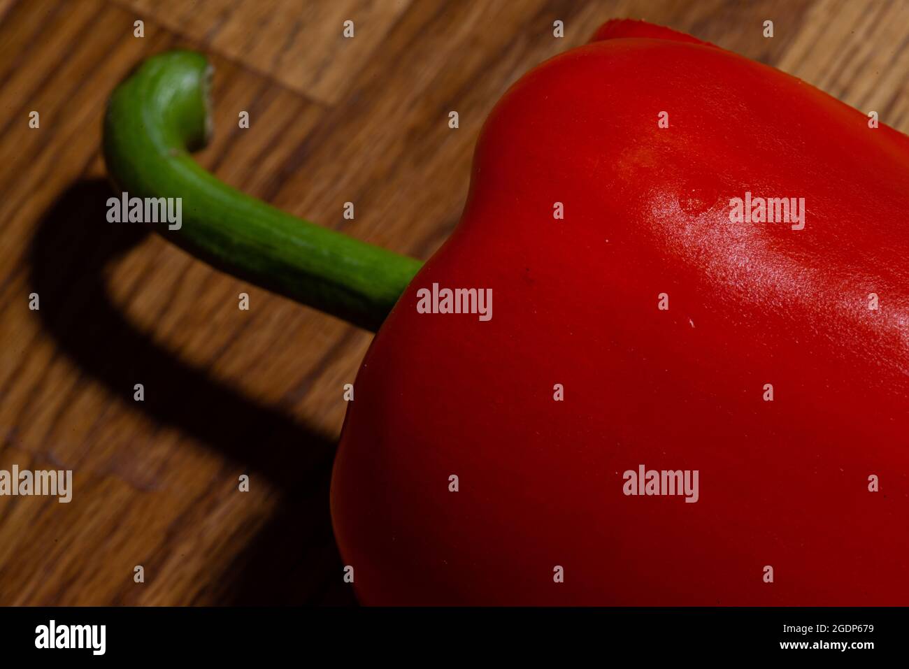 Red bell capsicum pepper on a table Stock Photo - Alamy