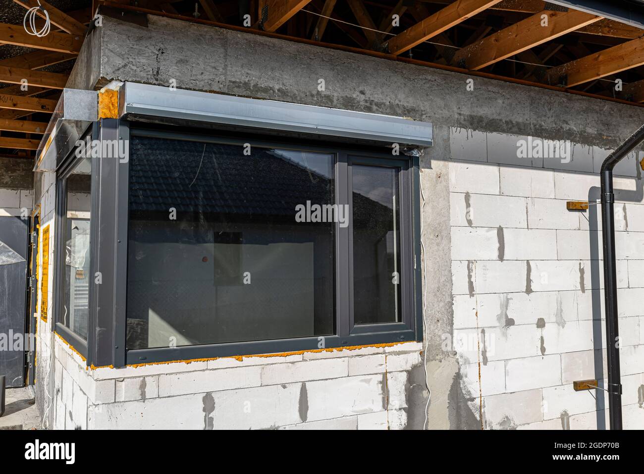Newly installed corner window with roller shutters in the house under ...