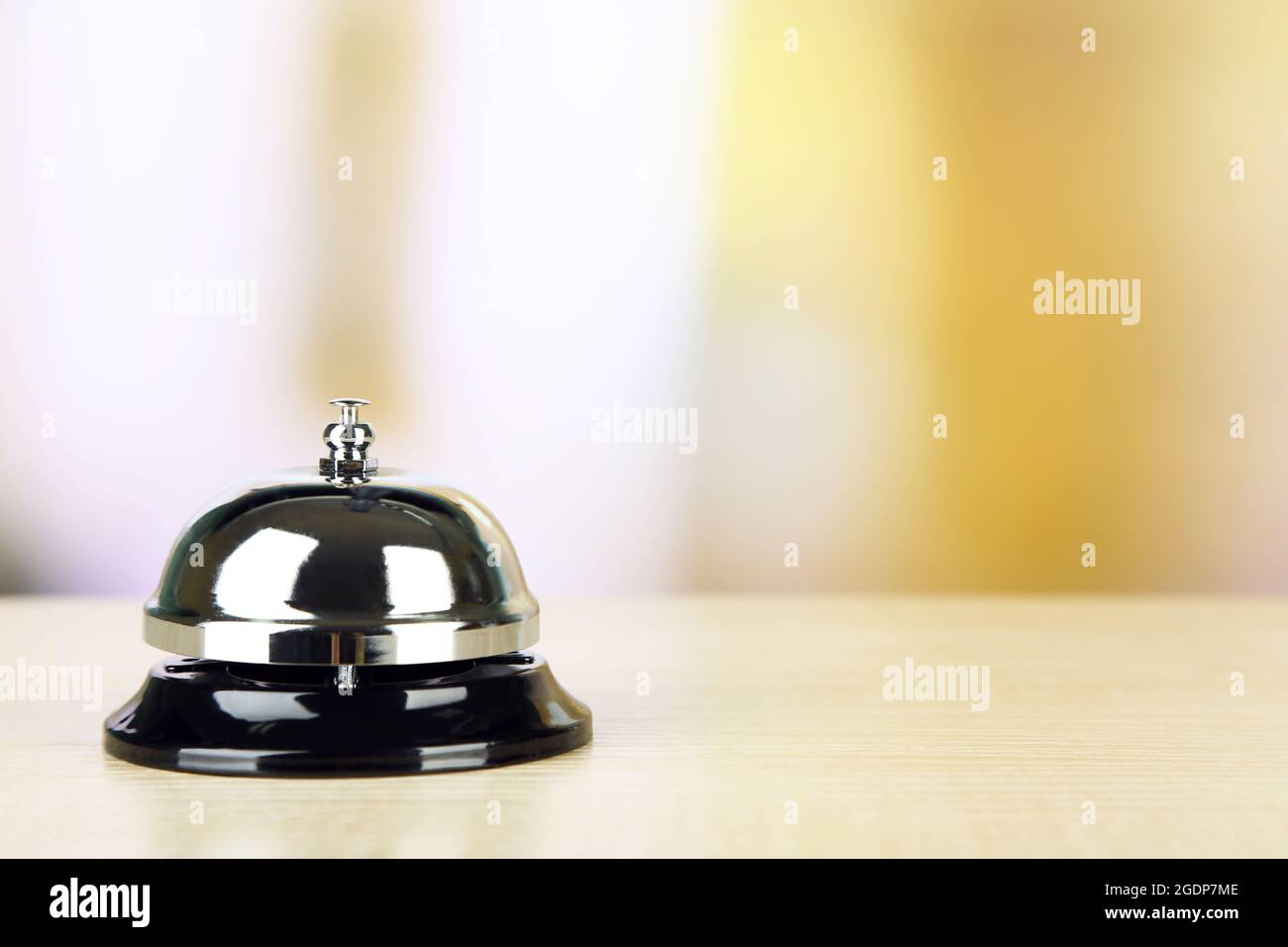 Reception bell on desk, on bright background Stock Photo - Alamy