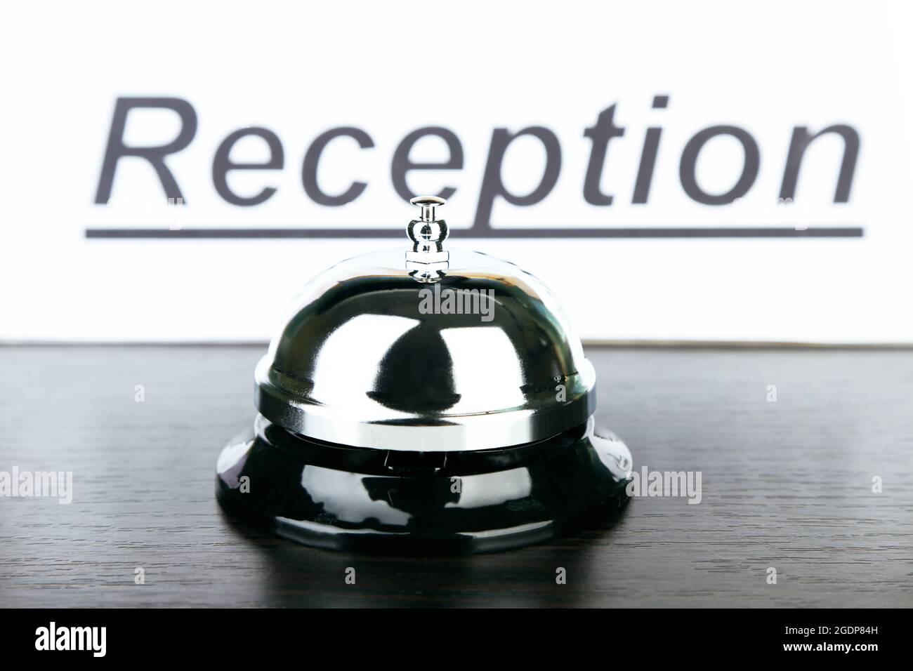 Reception bell on desk, on bright background Stock Photo - Alamy