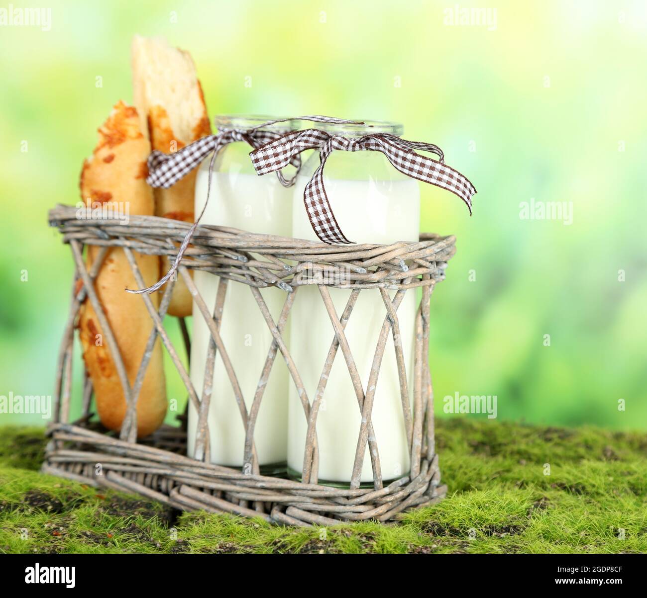 Bottles of tasty milk on nature background Stock Photo - Alamy