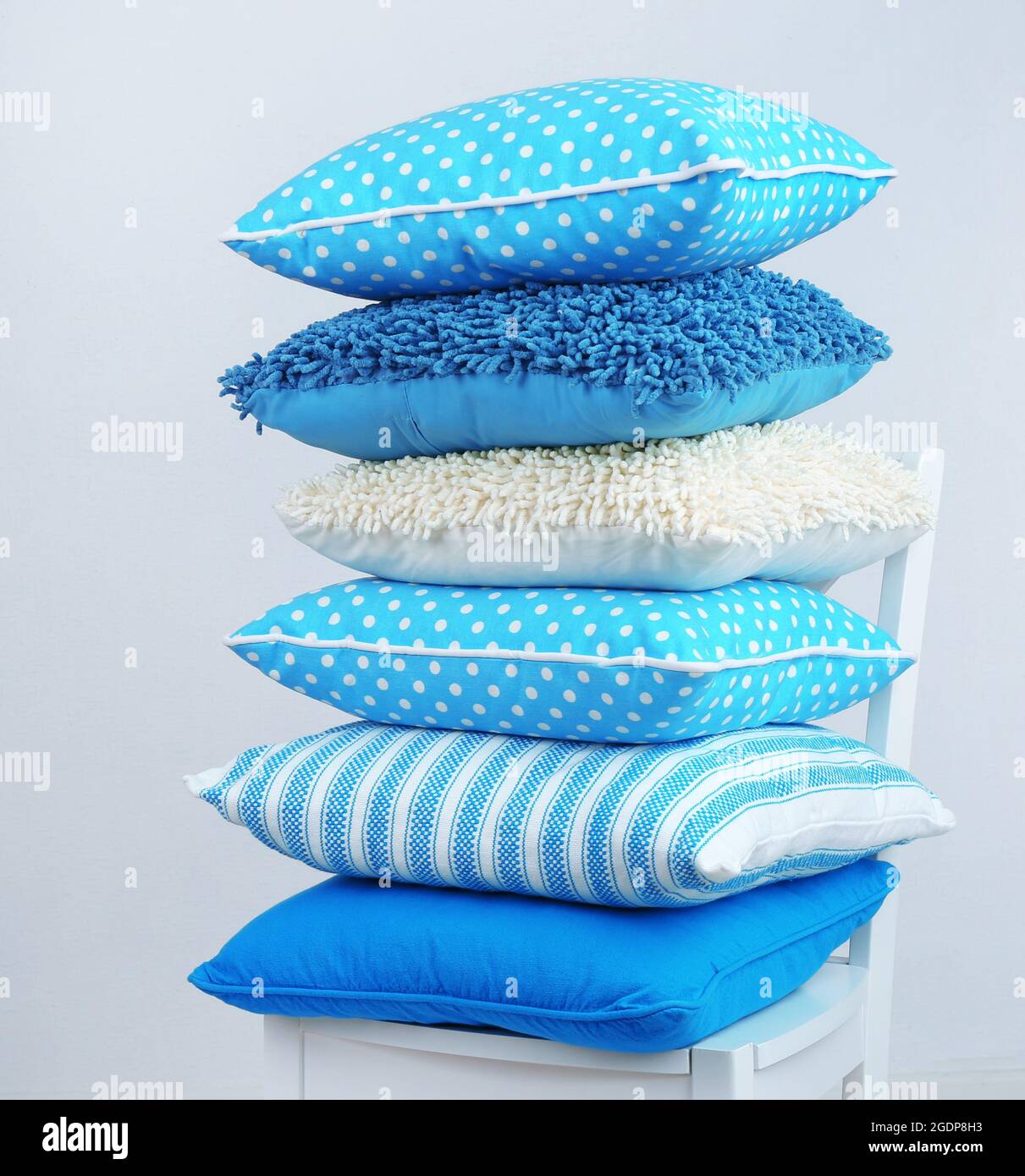 Bright pillows on chair in room Stock Photo - Alamy