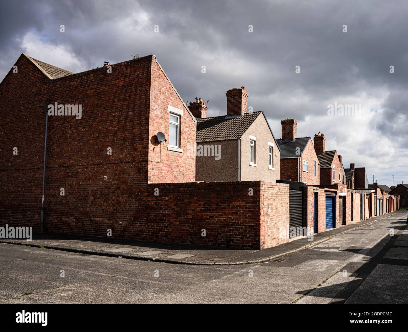 Back street of terraced housing in Ashington, Northumberland, a post ...