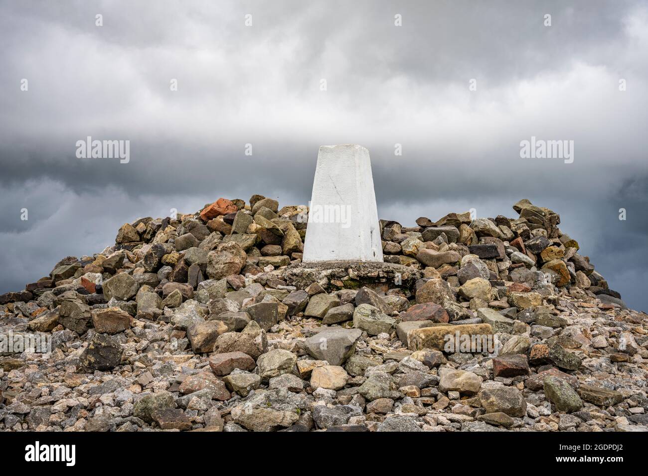 Triangulation pillar (trig point) and cairn at the summit of Windy Gyle ...