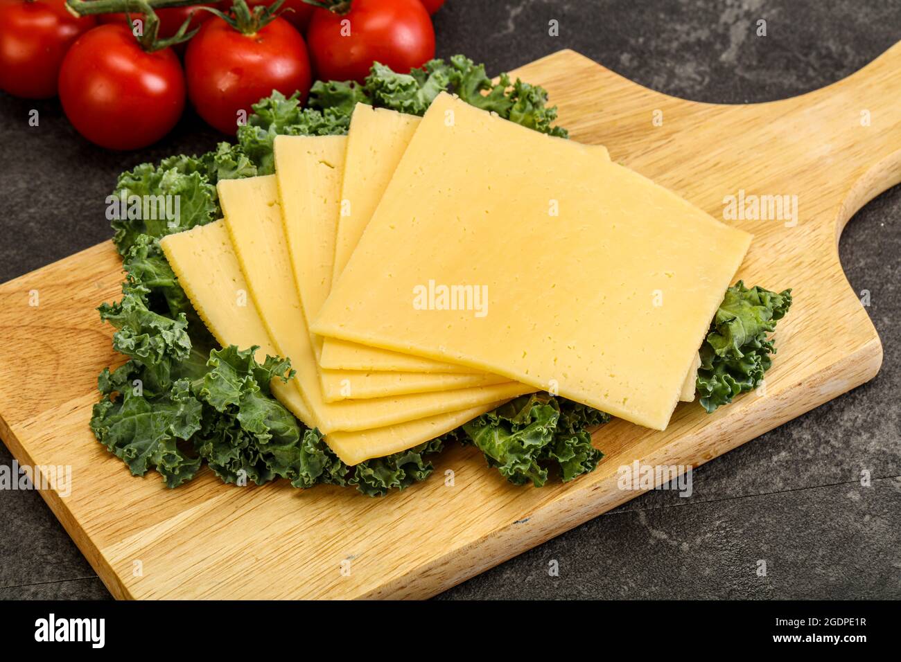 Sliced Gauda cheese snack over board Stock Photo - Alamy
