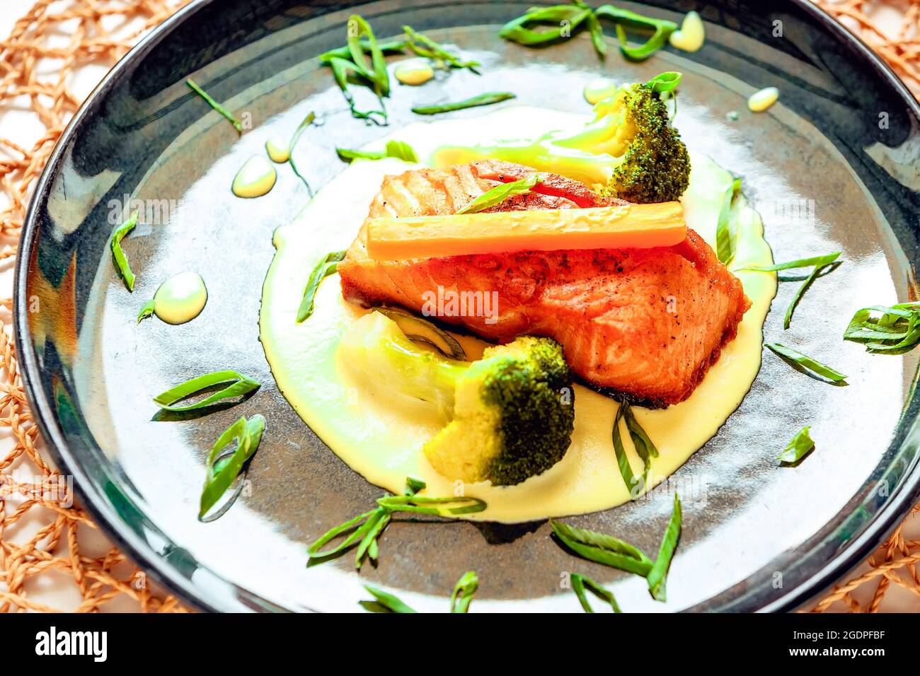 Salmon fish with broccoli in white sauce Stock Photo - Alamy