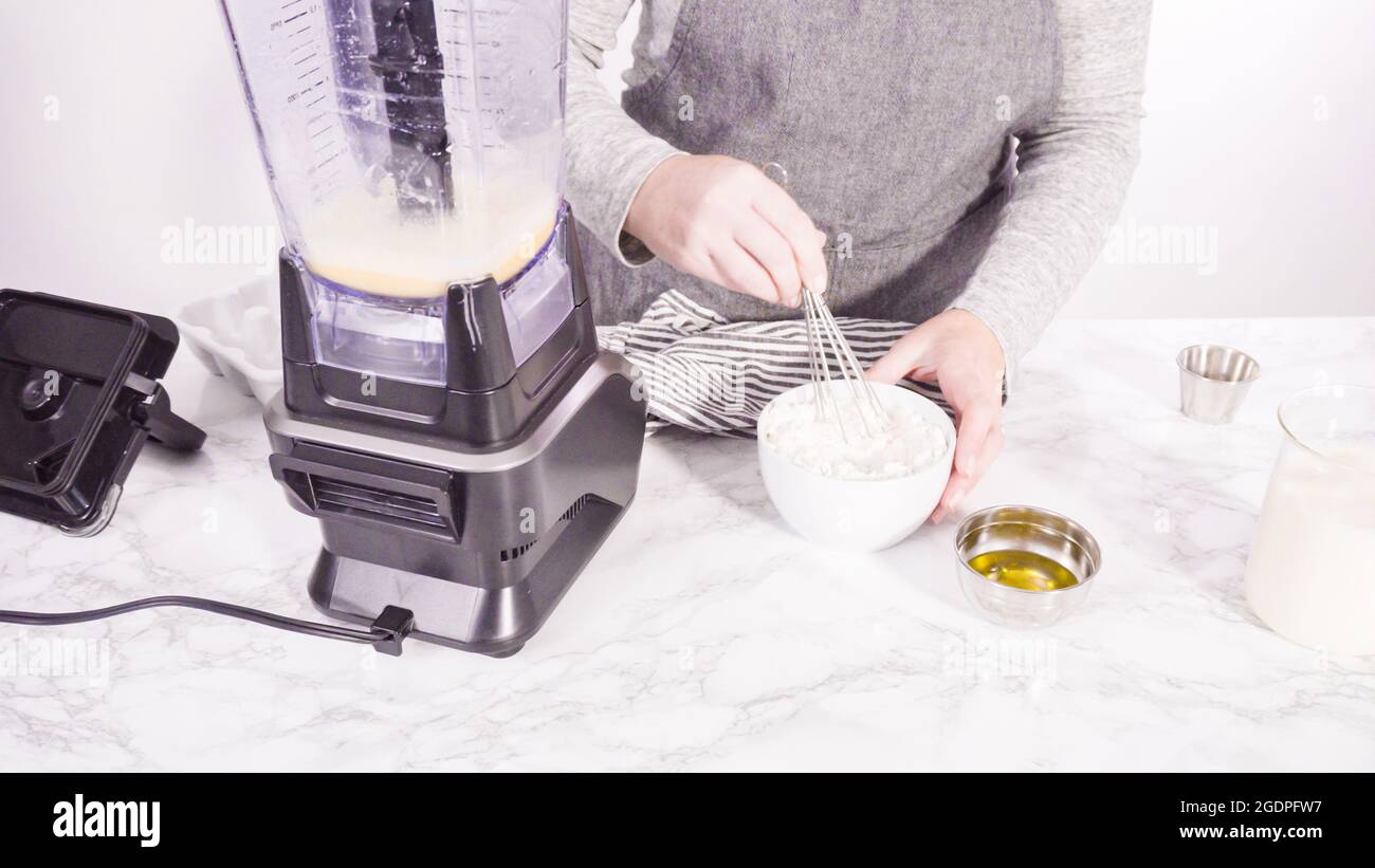 Mixing ingredient in an electric blender to make the crepes batter Stock Photo - Alamy