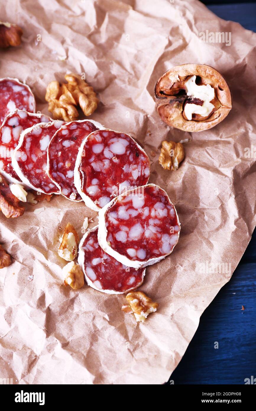 French salami and walnuts on craft paper background Stock Photo - Alamy