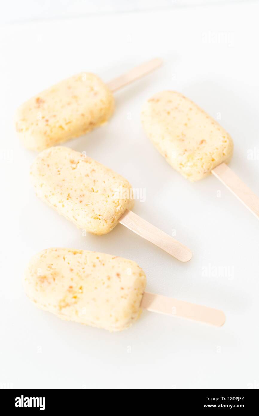 Dipping frozen cakesicles into melted chocolate to prepare mermaid ...