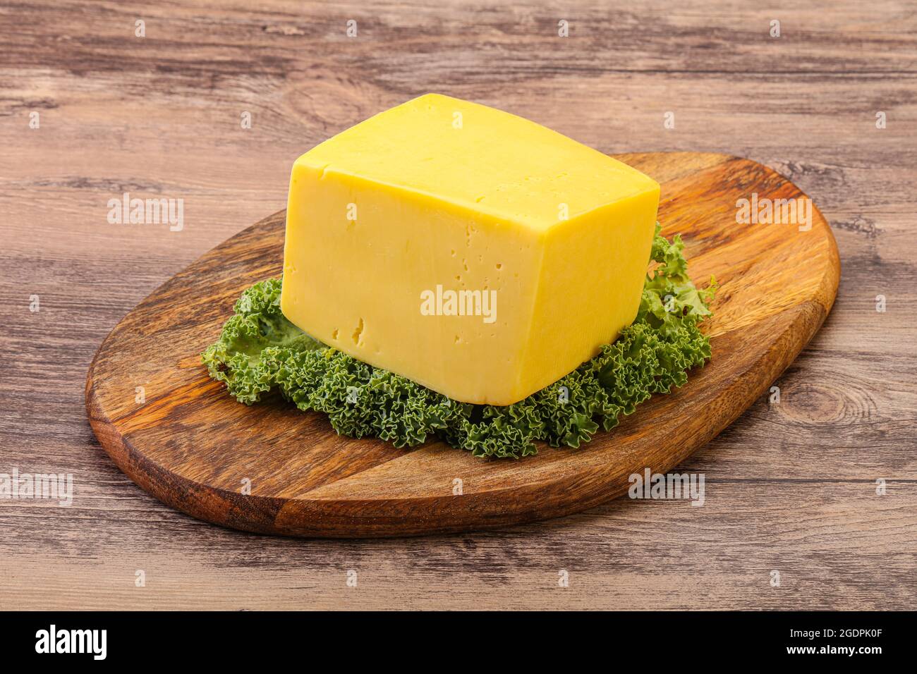 Yellow tilsiter cheese dairy product brick Stock Photo - Alamy