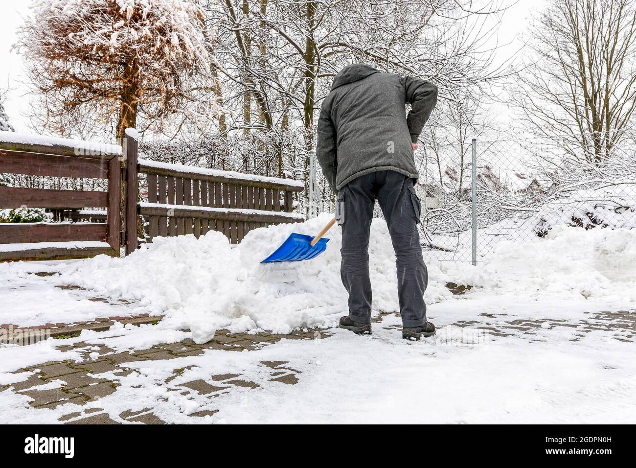 Man removing snow from the sidewalk after snowstorm. Winter time Stock ... Man removing snow from the sidewalk after snowstorm. Winter time Stock ...