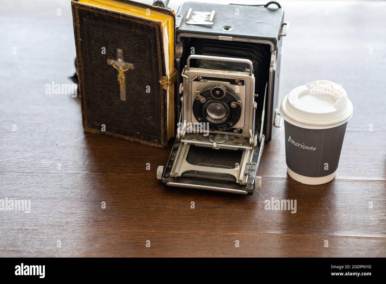 Shot of bible in leather cover with golden cross, vintage camera ...