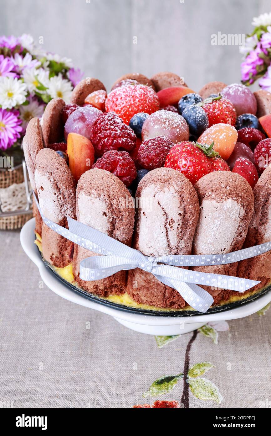 French charlotte cake with summer fruits. Party dessert Stock Photo - Alamy