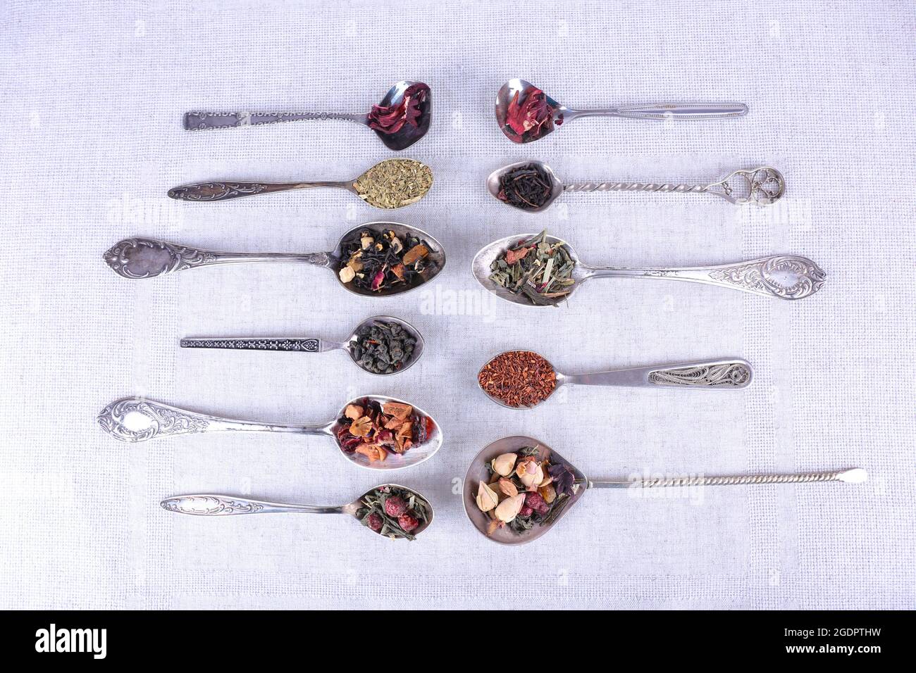 Tea in metal spoons on fabric background Stock Photo - Alamy