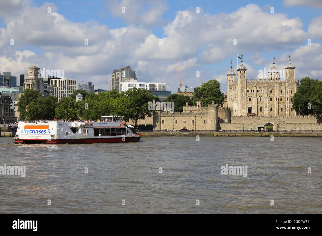 Tourist cruise boat passing the Tower of London, on the River Thames ...